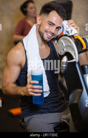 Bodybuilder with muscles biceps, triceps smiling on sunny day. Sport ...