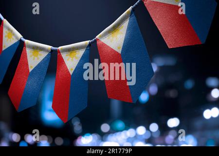 A garland of Philippines national flags on an abstract blurred ...