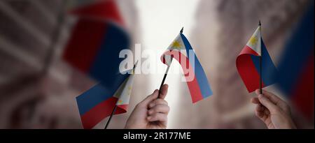 Hands Holding Flag of the Nation Philippines Stock Photo - Alamy