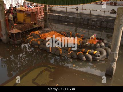 Nepal, Kathmandu, Budhanilakantha: Puja ceremony, with Vishnu lying on ...