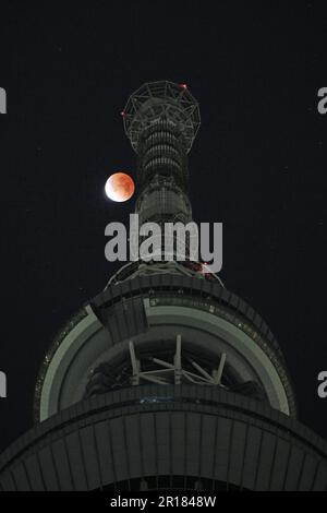 Total lunar eclipse and Tokyo sky tree Stock Photo - Alamy