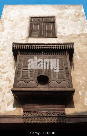 Traditional Arabic mashrabiya window on a tiled wall enclosed with ...