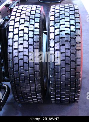 Black rubber heavy duty tyres of a construction equipment - top angled ...