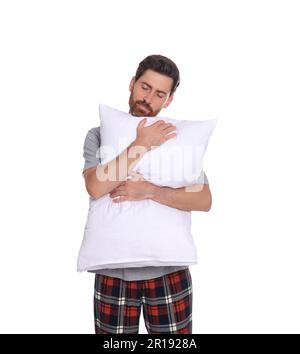 Sleepy handsome man hugging soft pillow on light grey background Stock ...