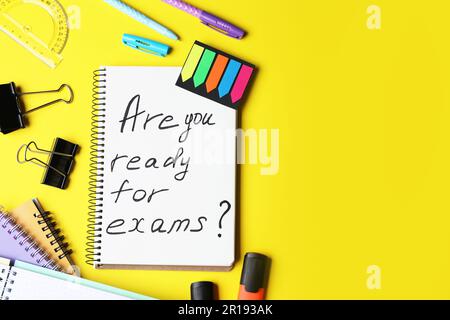 Stationery and notebook with text ARE YOU READY FOR EXAMS? on color ...