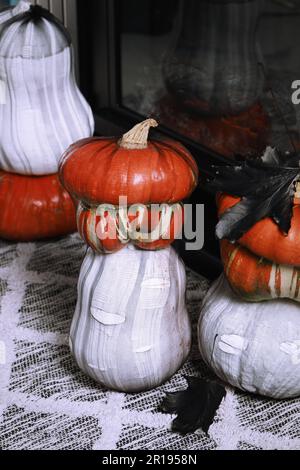White fireplace with Halloween pumpkins and decorations near green wall ...