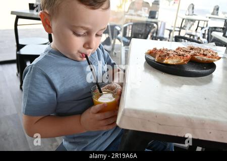 Nothing better than a good breakfast. A cute little boy eating toast ...