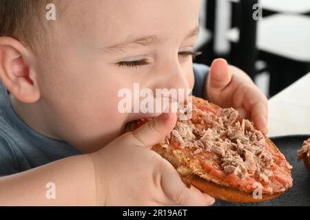 Nothing better than a good breakfast. A cute little boy eating toast ...