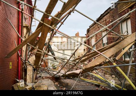 Building scaffold collapsed in alleyway Stock Photo - Alamy