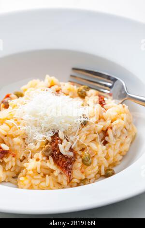 Italian risotto with dry tomatoes and capers Stock Photo - Alamy