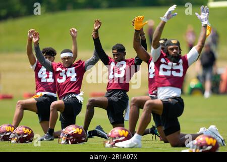 Washington Commanders cornerback Emmanuel Forbes Jr. walks to the field ...