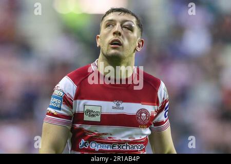 Jake Wardle #4 of Wigan Warriors is tackled during the Betfred Super ...
