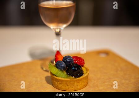Wine with a tarlet with fruit Stock Photo - Alamy