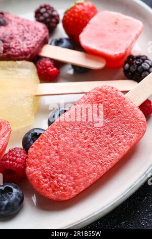 Different tasty ice pops on pale green background, flat lay. Fruit ...