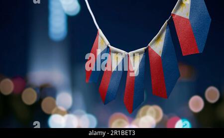 A garland of Philippines national flags on an abstract blurred ...