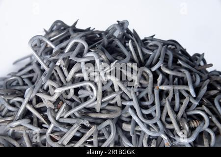 pile of heavy barbed wire staples for construction and carpentry Stock ...