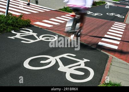 Bicycle road sign and bike riders Stock Photo - Alamy