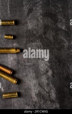 Empty bullet cartridges lying on the black background Stock Photo - Alamy