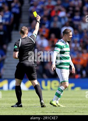 Referee Steven McLean shows a yellow card to Rangers' Dujon Sterling ...
