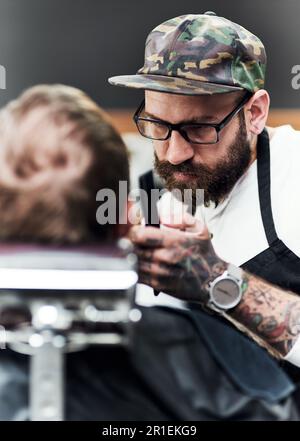 Modern barber holding hair clipper at barbershop Stock Photo - Alamy