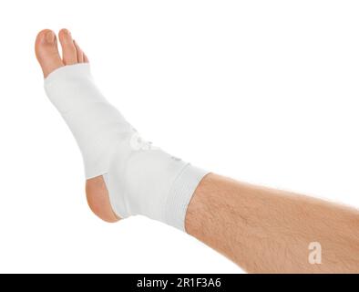 Man with foot wrapped in medical bandage on white background, closeup ...