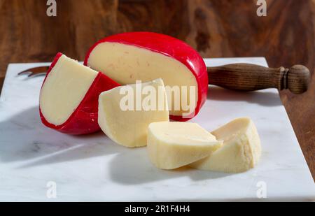 British red waxed original cheddar cheese madse from cow milk close up ...