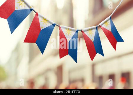 A garland of Philippines national flags on an abstract blurred ...