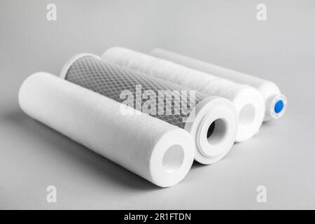 New water filter cartridges on grey background Stock Photo - Alamy