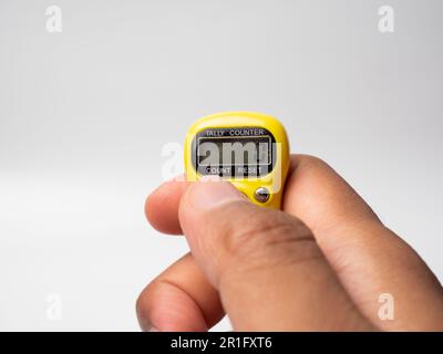 Picture of a yellow digital tally counter on a white background Stock ...