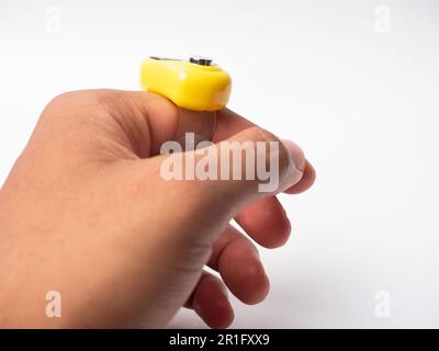 Picture of a yellow digital tally counter on a white background Stock ...