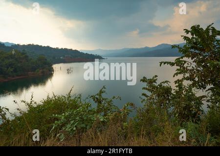 The placid waters of Gunjawani Dam Reservoir near Velhe in Maharashtra ...
