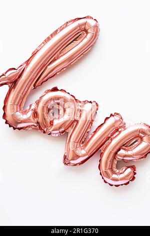 Word BIRTHDAY made of pink foil balloon letters on white background ...