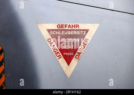Caution warning sign on fuselage and wings of modern jet fighter ...