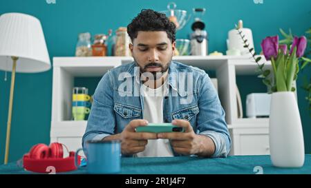 African american gamer relaxing playing online action game using pc ...