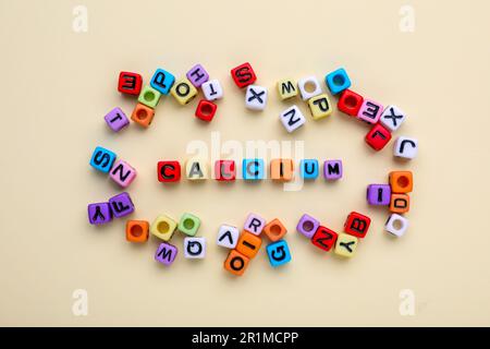 Different colorful beads on beige background Stock Photo - Alamy