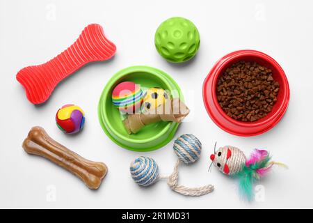 Flat lay composition with pet toys, food and accessories on light blue ...