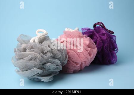 Colorful shower puffs on light blue background, flat lay Stock Photo ...