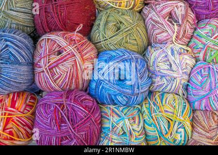 Different coloured balls of wool, frame, copying space in the middle ...