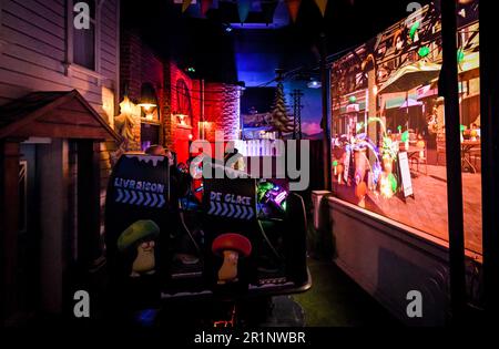 People try out the "Champi'folies' dark ride at Le Pal in France Stock ...