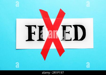 Card with optimistic word Fixed on light blue background. Letter X made ...