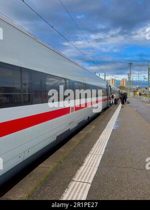 Intercity Express of Deutsche Bahn drives through the countryside ...