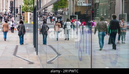 Street scene with passersby reflected in a glass window, St Paul's ...