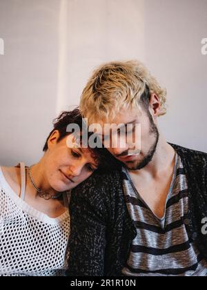 Non-binary couple on sofa Stock Photo - Alamy