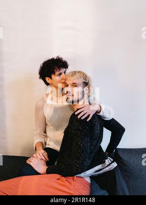 Non-binary couple on sofa Stock Photo - Alamy