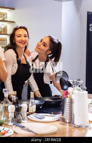 Two funny professional female chefs cooking food in large kitchen Stock ...