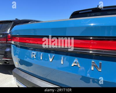 Close-up of a Rivian electric vehicle charging station sign with logo ...