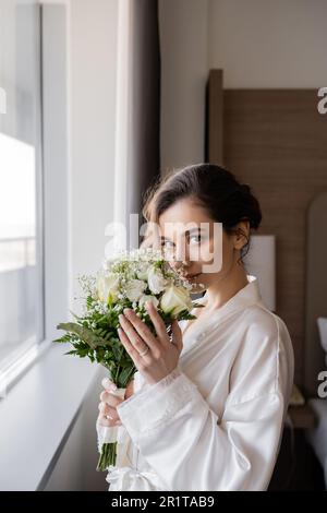 They smell as beautiful as the look. A gorgeous young bride smelling ...