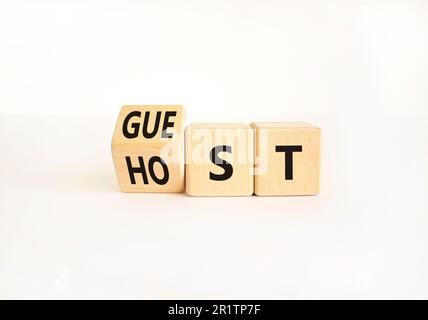 Guest and host symbol. Businessman turns wooden cubes and changes the ...