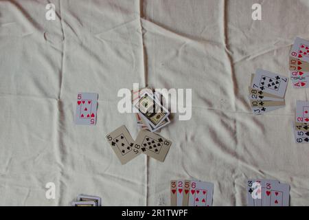 playing cards scattered on the table texture background Stock Photo - Alamy