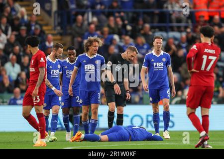 Referee Craig Pawson checks on an injured Robert Bozenik of Stoke City ...